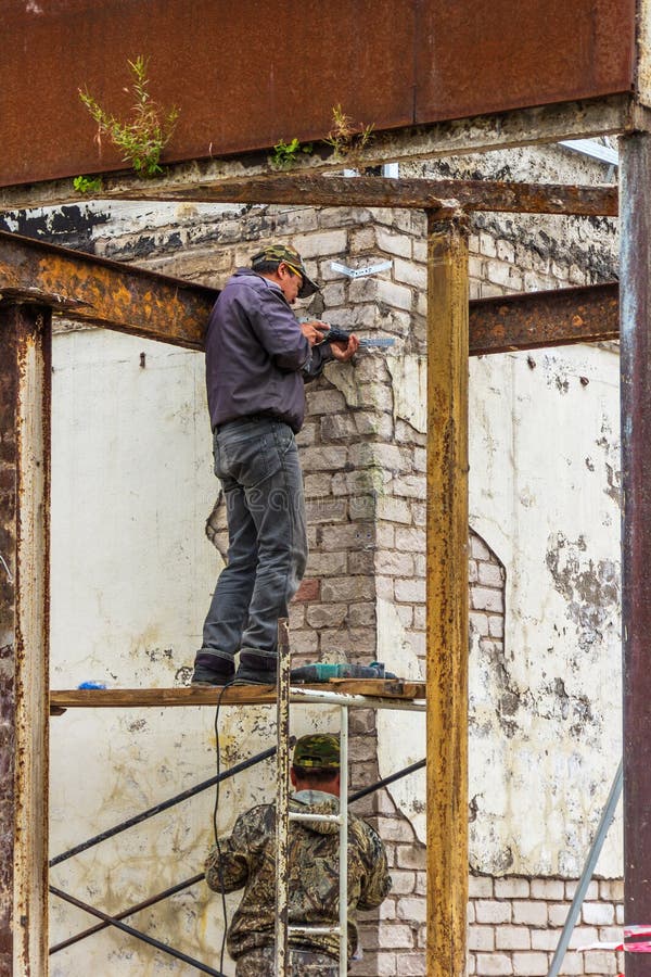 Workers Repair the Facade of the Building. Editorial Stock Photo ...