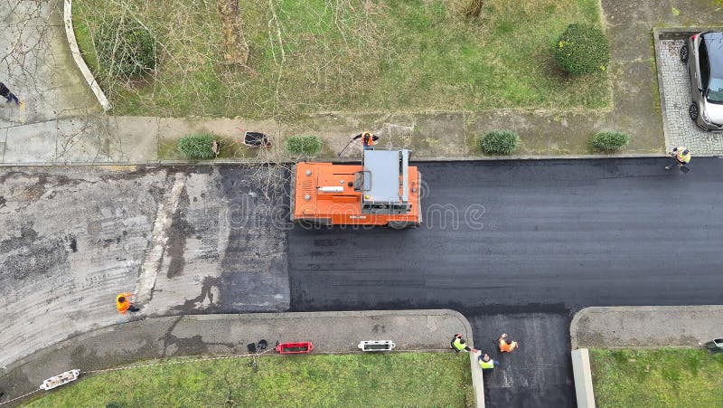 Workers Repave a Public Road with Fresh Asphalt, Using Heavy Machinery ...