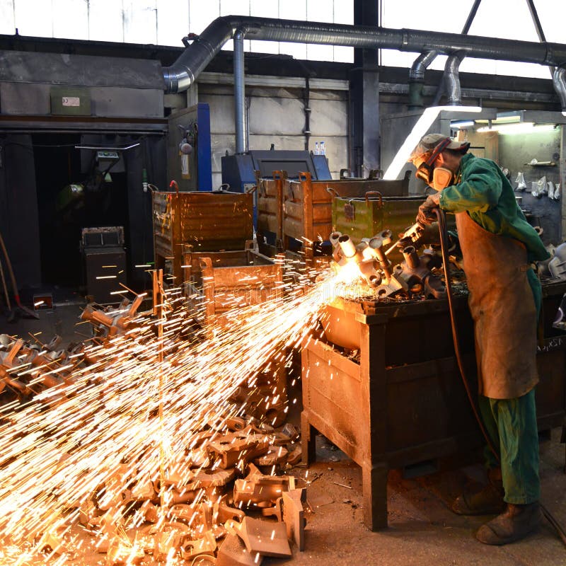 Workers in Safety Clothing Sanding a Casting in an Industrial Company ...