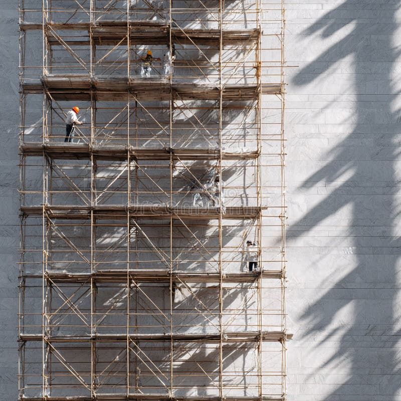 Workers on Scaffolding Against a Textured Wall, Symbolizing Progress, Teamwork, and Urban ...