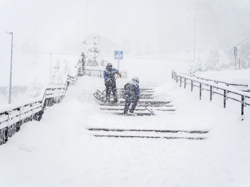 Workers Shovel Snow from Steps Outside during Heavy Snow Stock Image ...