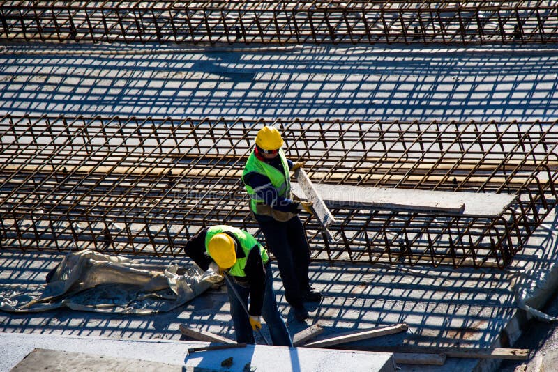 Workers by the Side of Iron Bars Reinforcement Concrete Bars with Wire ...