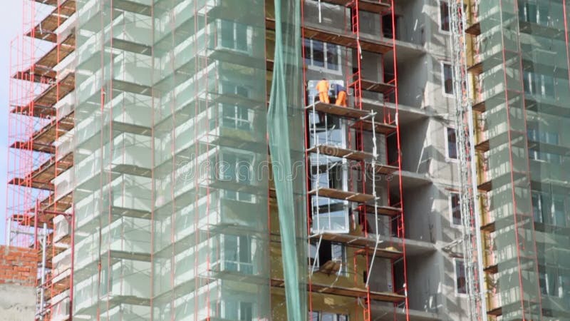 Workers Stand on Scaffold and Set Windows at Stock Footage - Video of ...