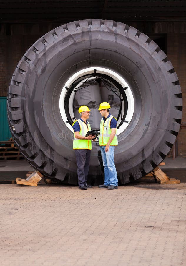 Workers standing tire stock photo. Image of adult, helmet - 31711696