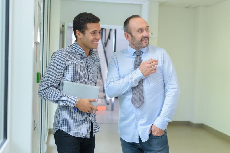 Workers Talking in Corridor Office Building Stock Photo - Image of ...
