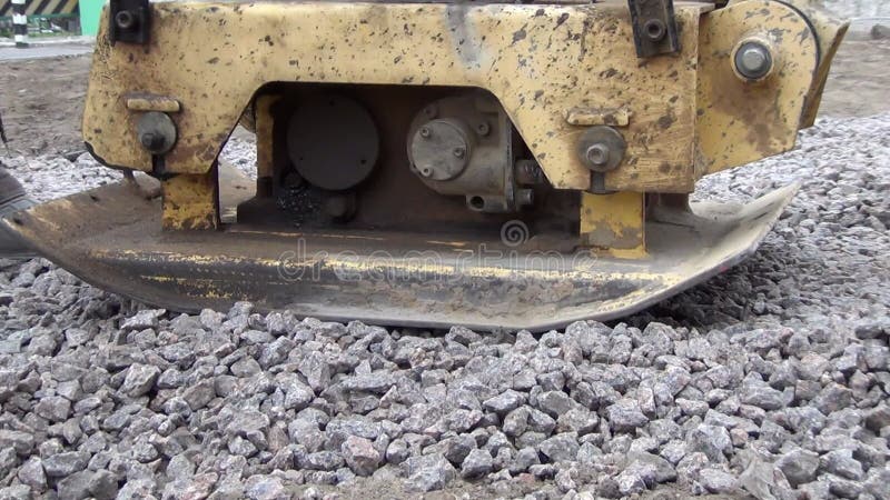 Workers Tamp Crushed Stone Using a Vibratory Plate Vibratory Rammer ...