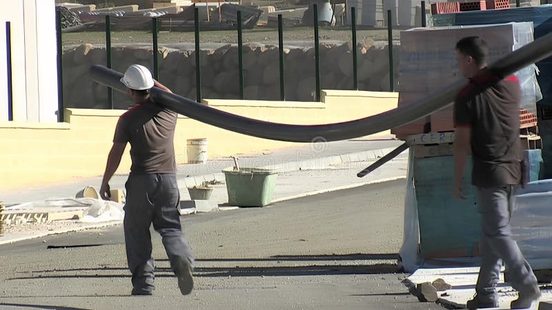 Workers Transporting a Big Pvc Pipe Stock Footage - Video of public ...
