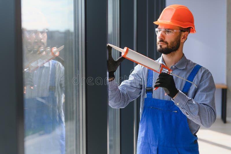 Workers with Tube of Sealant and Suction Lifters Installing Plastic ...