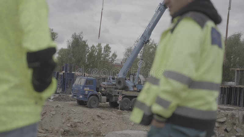 Workers in Uniform Stand Surrounded by Construction Site Stock Footage ...