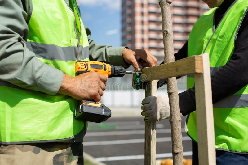Workers in Uniform are Using a Screwdriver To Prepare a Support for ...
