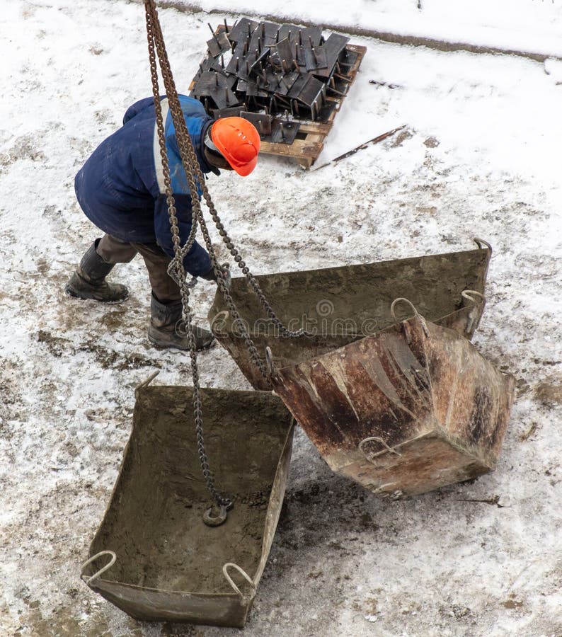 Workers Unload Containers from Concrete from a Crane at a Construction ...