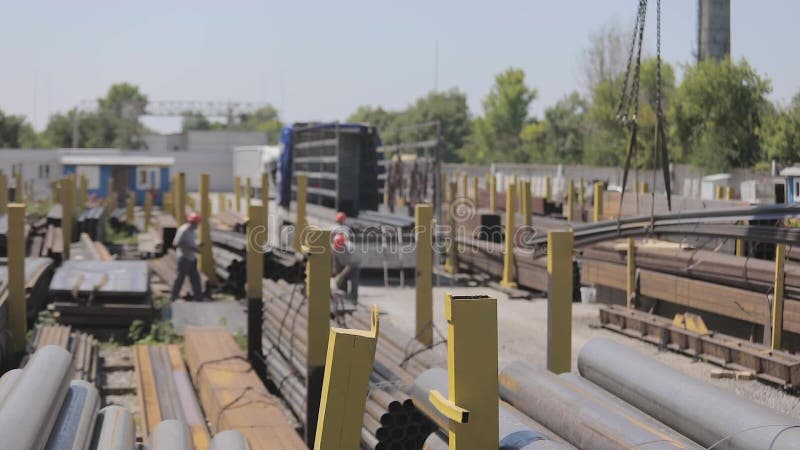 The Working Process in a Warehouse with a Metal. Workers Unload a Metal ...