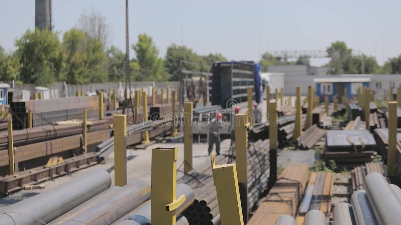 The Working Process in a Warehouse with a Metal. Workers Unload a Metal ...