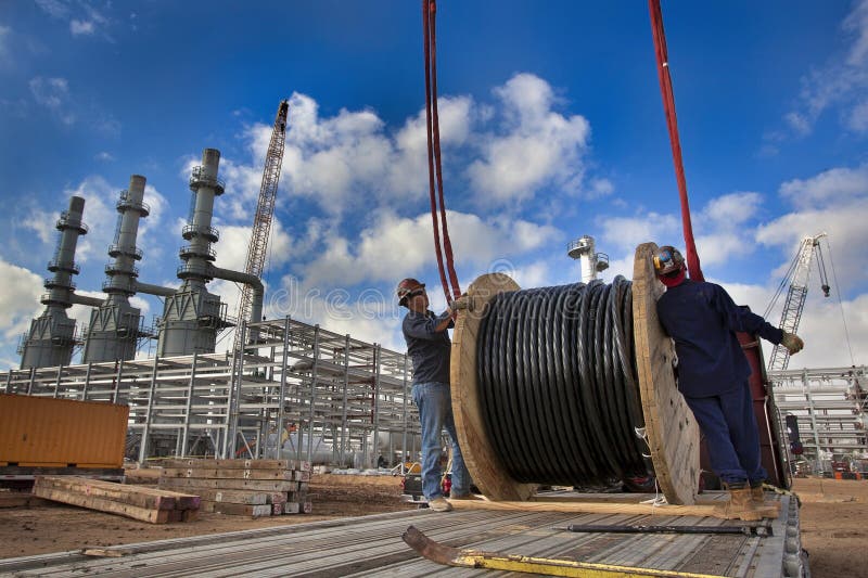 Workers Unloading Cable at Natural Gas Plant Construction. Editorial ...