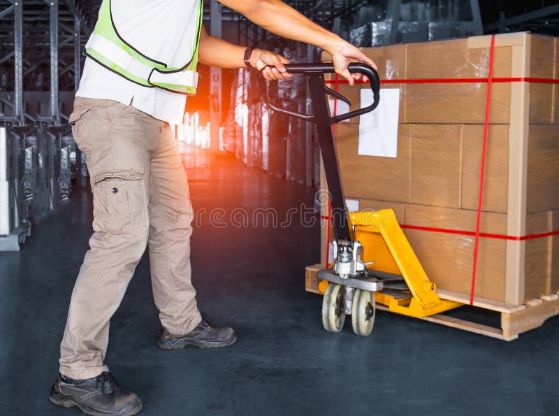 Workers Unloading Package Boxes on Pallet in Warehouse. Supply Chain ...