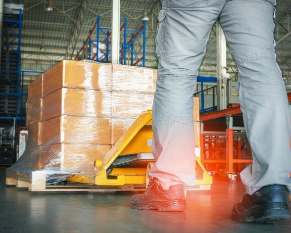 Workers Unloading Package Boxes on Pallet in Warehouse. Delivery ...