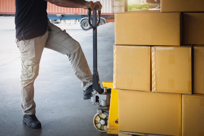 Workers Unloading Package Boxes on Pallets in Warehouse. Cartons ...