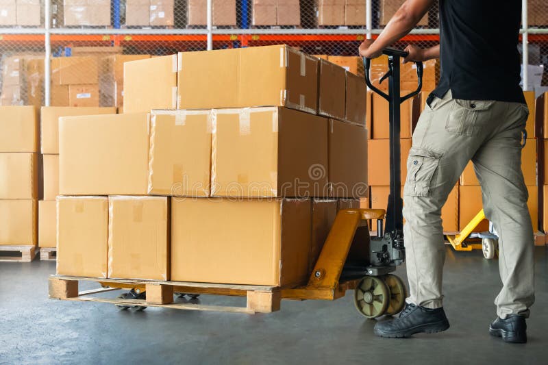 Workers Unloading Package Boxes on Pallets in Warehouse. Supply Chain ...