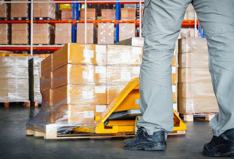 Workers Unloading Package Boxes on Pallets in Warehouse. Supply Chain ...