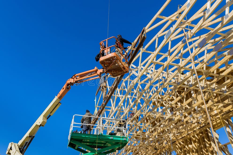Construction Workers Assembling Wooden Structure on Clear Day in ...