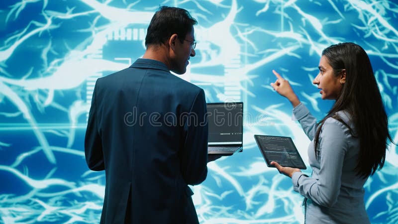 Workers Using Artificial Intelligence Deep Learning To Look at Data ... Workers Using Artificial Intelligence Deep Learning To Look at Data ...