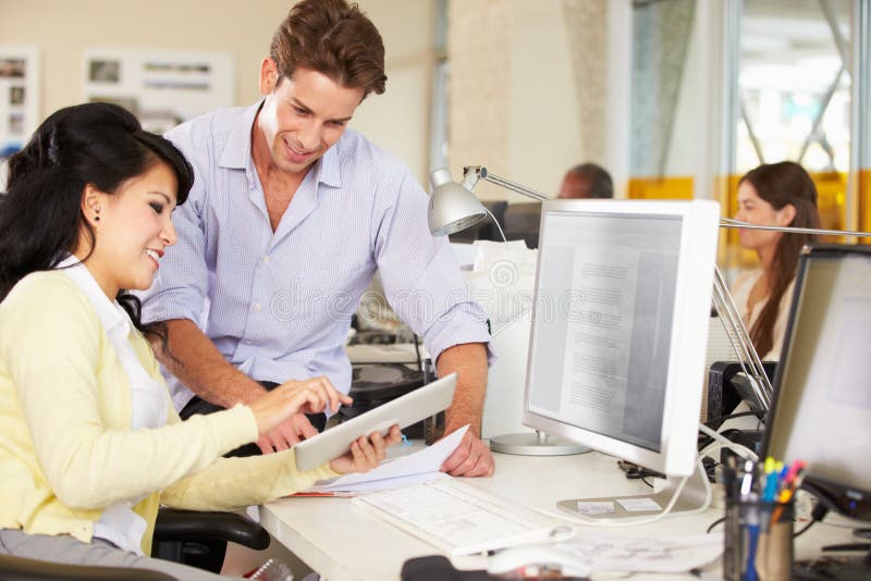 Workers Using Digital Tablet in Busy Creative Office Stock Image ...