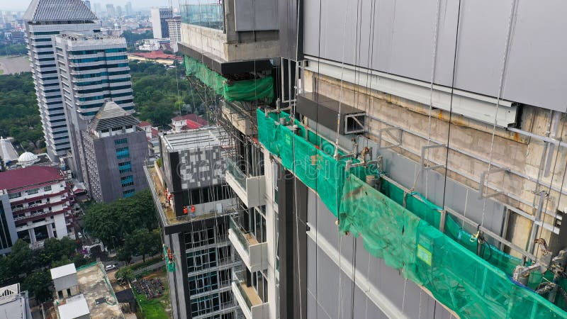 Workers are Using Gondola As Vertical Trasport To Install Aluminum ...