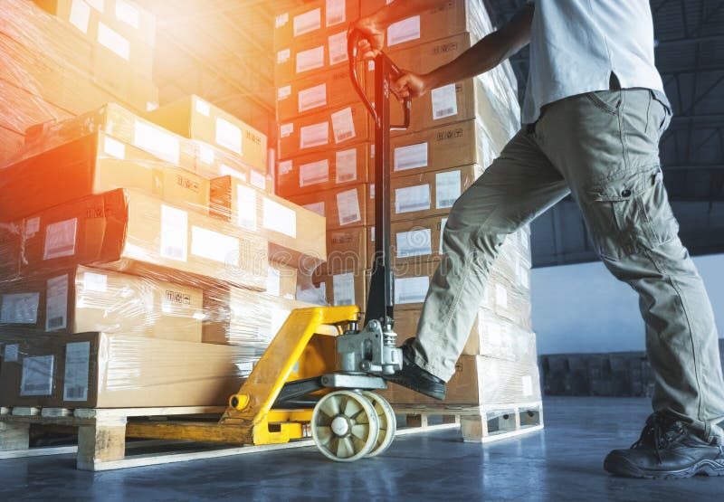 Workers Using Hand Pallet Jack Unloading Package Boxes. Commerce Supply ...
