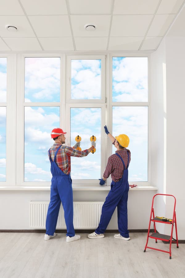 Workers Using Suction Lifters during Plastic Window Installation ...