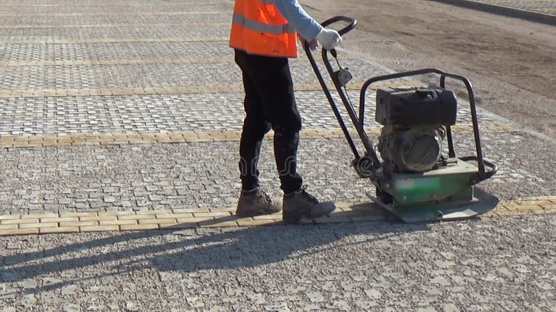 Workers Using a Vibro-compacting Plate To Compact Self-locking Blocks ...