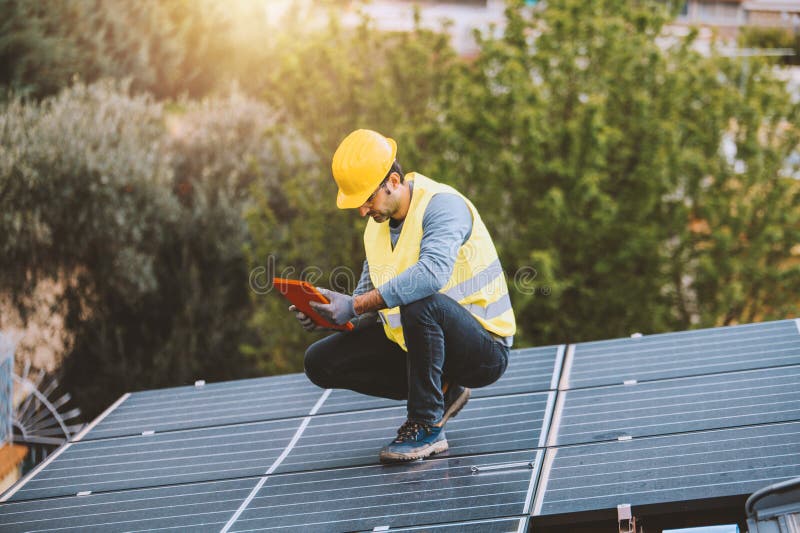 Workers Verify Energy System with Solar Panel with a Tablet Stock Photo ...