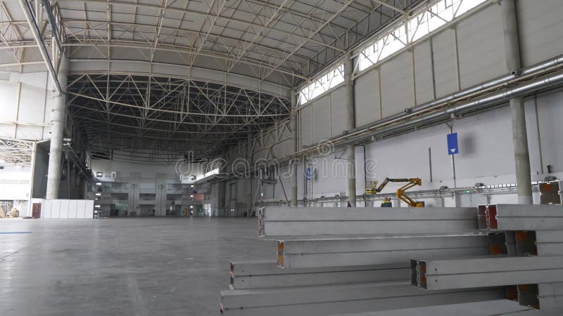 Workers Walks through Huge Warehouse. Big Empty Warehouse of Finished ...