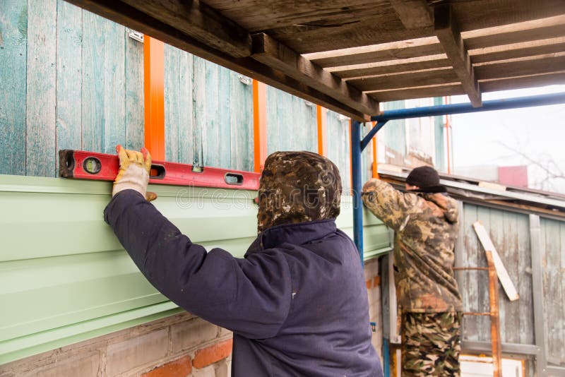 Workers Walling the House with Wall Siding Stock Photo - Image of wall ...