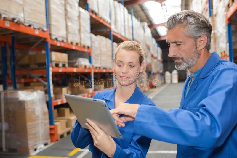 2 workers in warehouse stock image. Image of handsome - 257189179