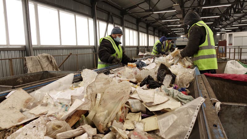 Workers at the Waste Processing Plant. Sorting Trash on a Conveyor Belt ...