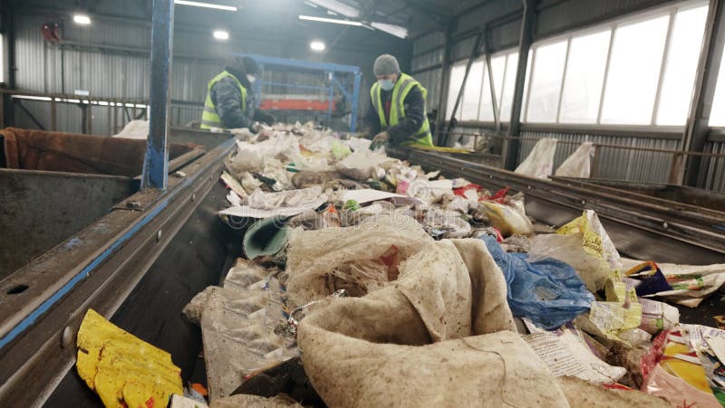 Workers at the Waste Processing Plant. Sorting Trash on a Conveyor Belt ...