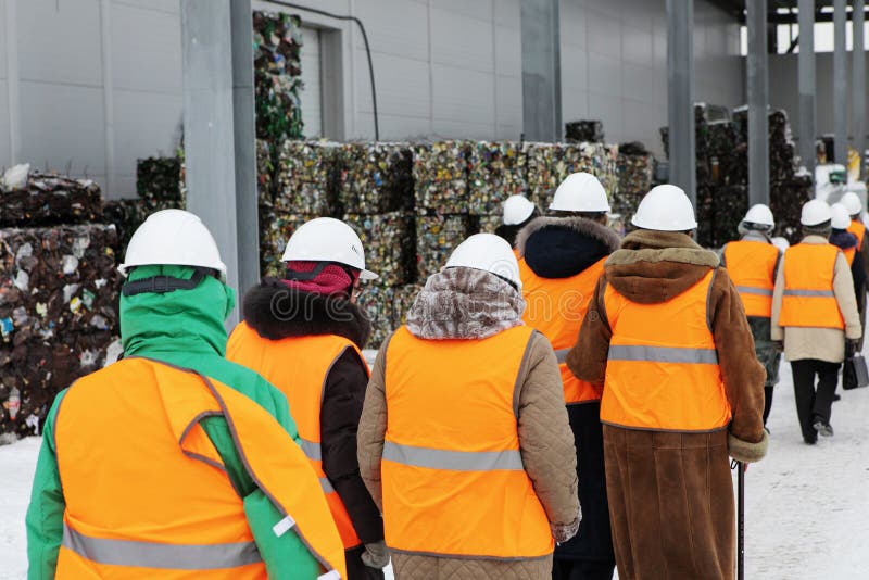 Workers at a Waste Recycling Plant in Special Clothes Go To Work. No ...