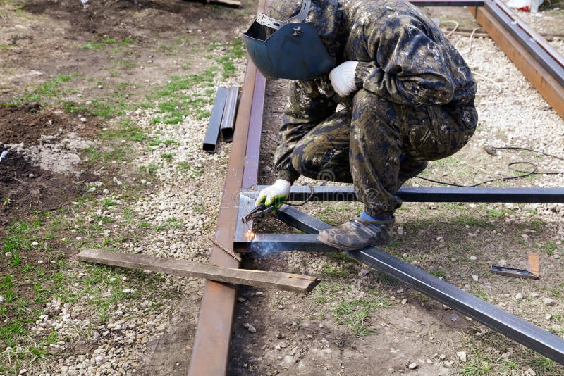 Workers Weld Metal for Sliding Gates. Stock Photo - Image of iron ...
