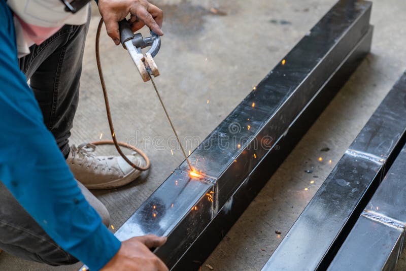 The Workers are Welding the Joint of Metal Square Poles Stock Photo ...
