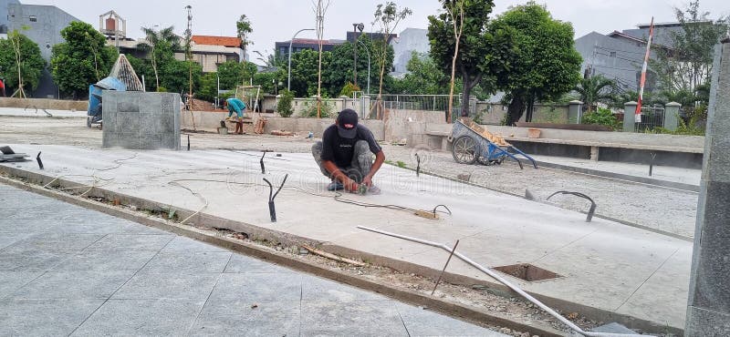 Workers Who are Making Floor Patterns on a Cast Floor Using a Grinder ...