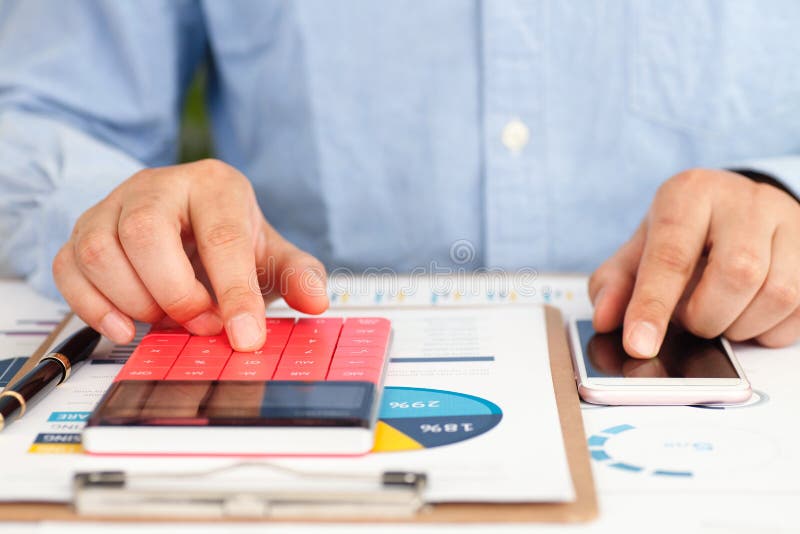 Workers Who Use Mobile Phones while Using Calculators Stock Image ...
