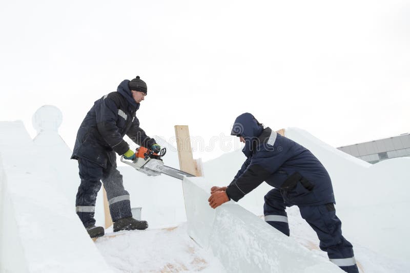 Workers in Winter Workwear Installing Ice Panels Stock Image - Image of ...