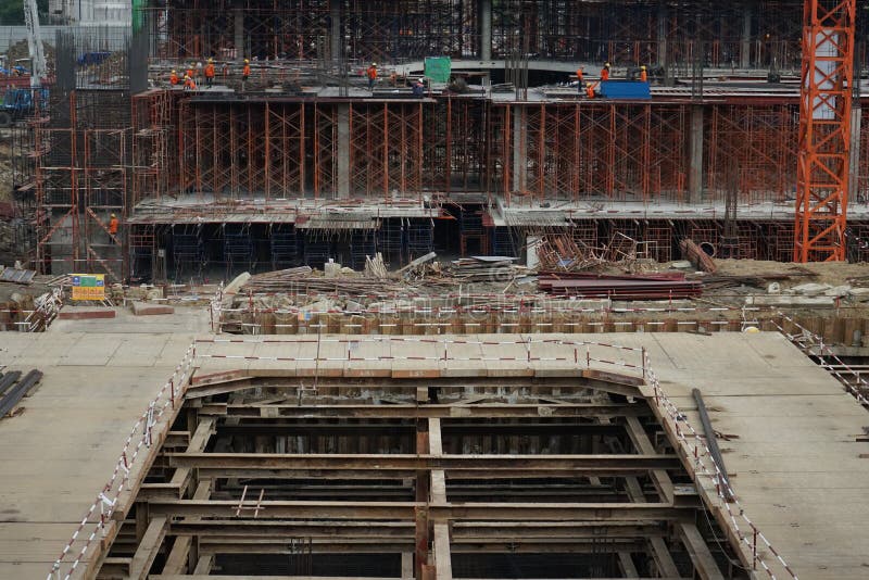 The Workers Work in the Building Under Construction with Many ...
