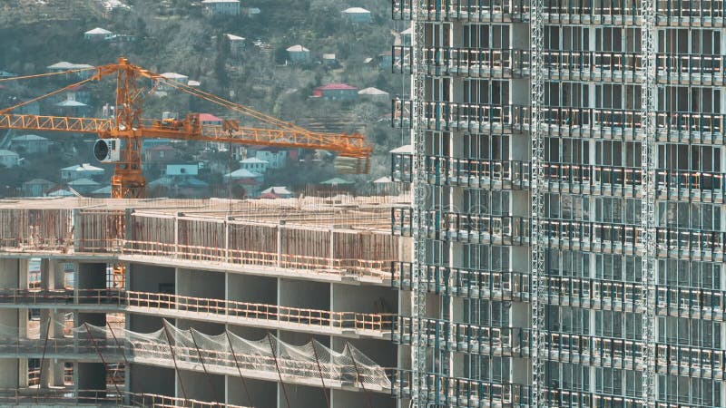 Workers Work in a Construction Cradle, on Scaffolding during the ...