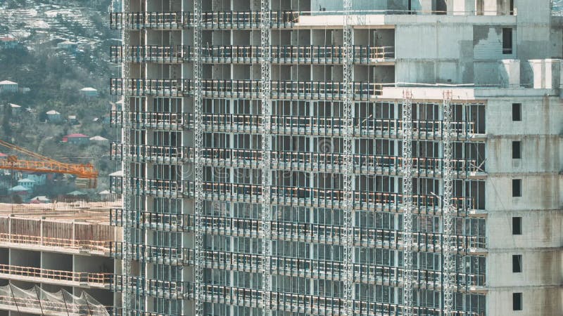 Workers Work in a Construction Cradle, on Scaffolding during the ...
