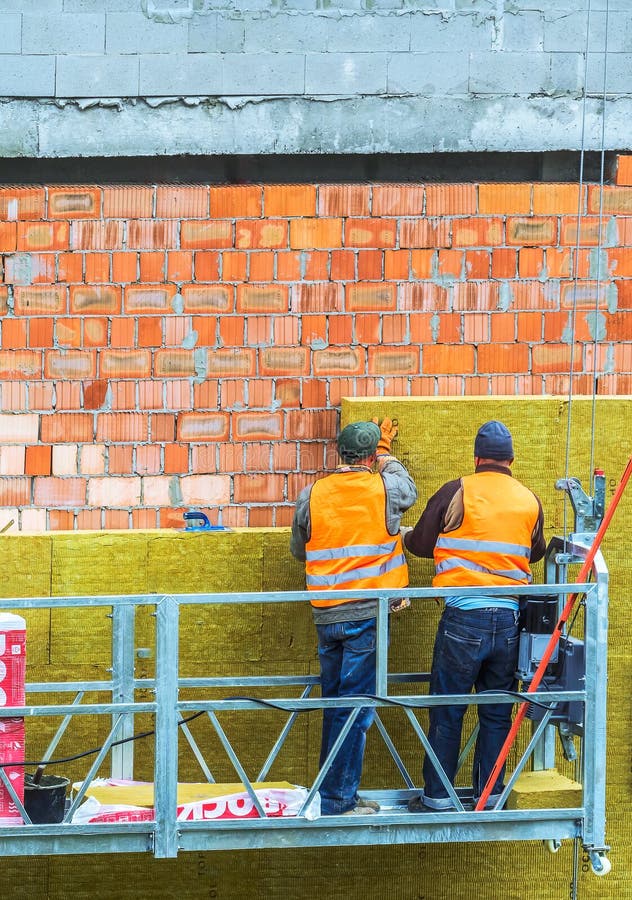 Workers Work on a Construction Site. Work is Underway on the Laying of ...