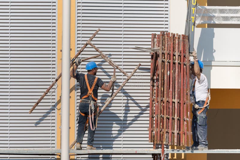 Workers at Work on a Scaffold in a Building Site for the Construction ...