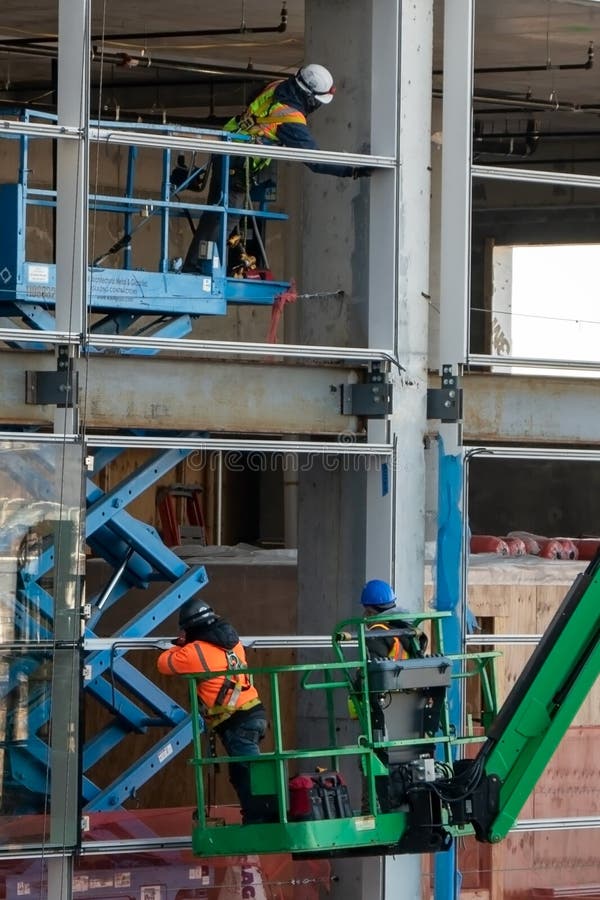 Workers are Working on the Construction Site in the Warehouse ...
