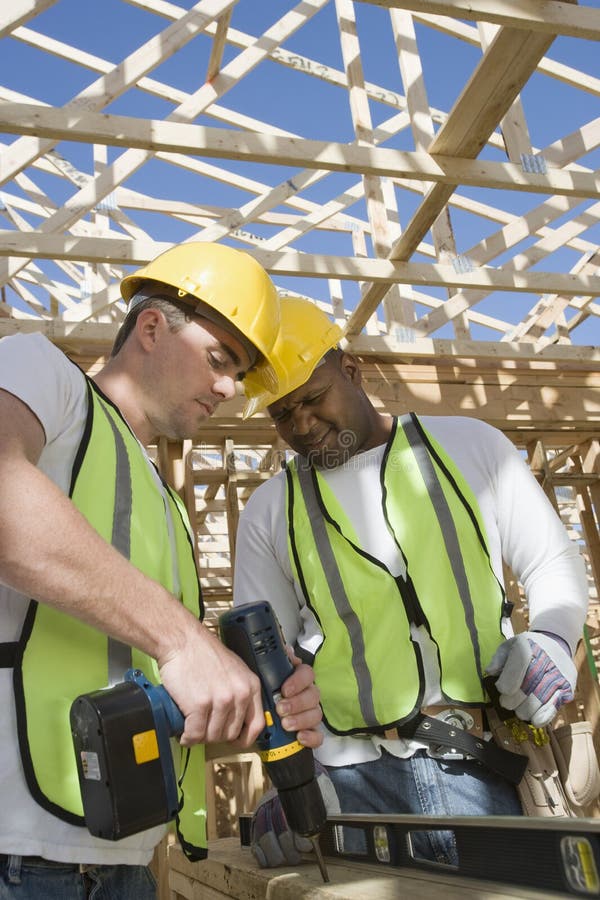 Carpenters Working at Construction Site Stock Photo - Image of jacket ...