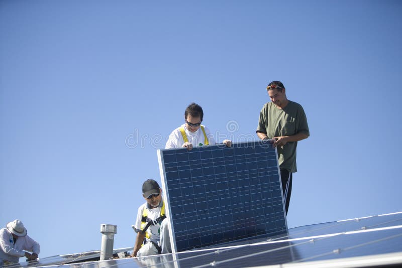 Workers Working on Solar Panel Against Blue Sky Stock Photo - Image of ...